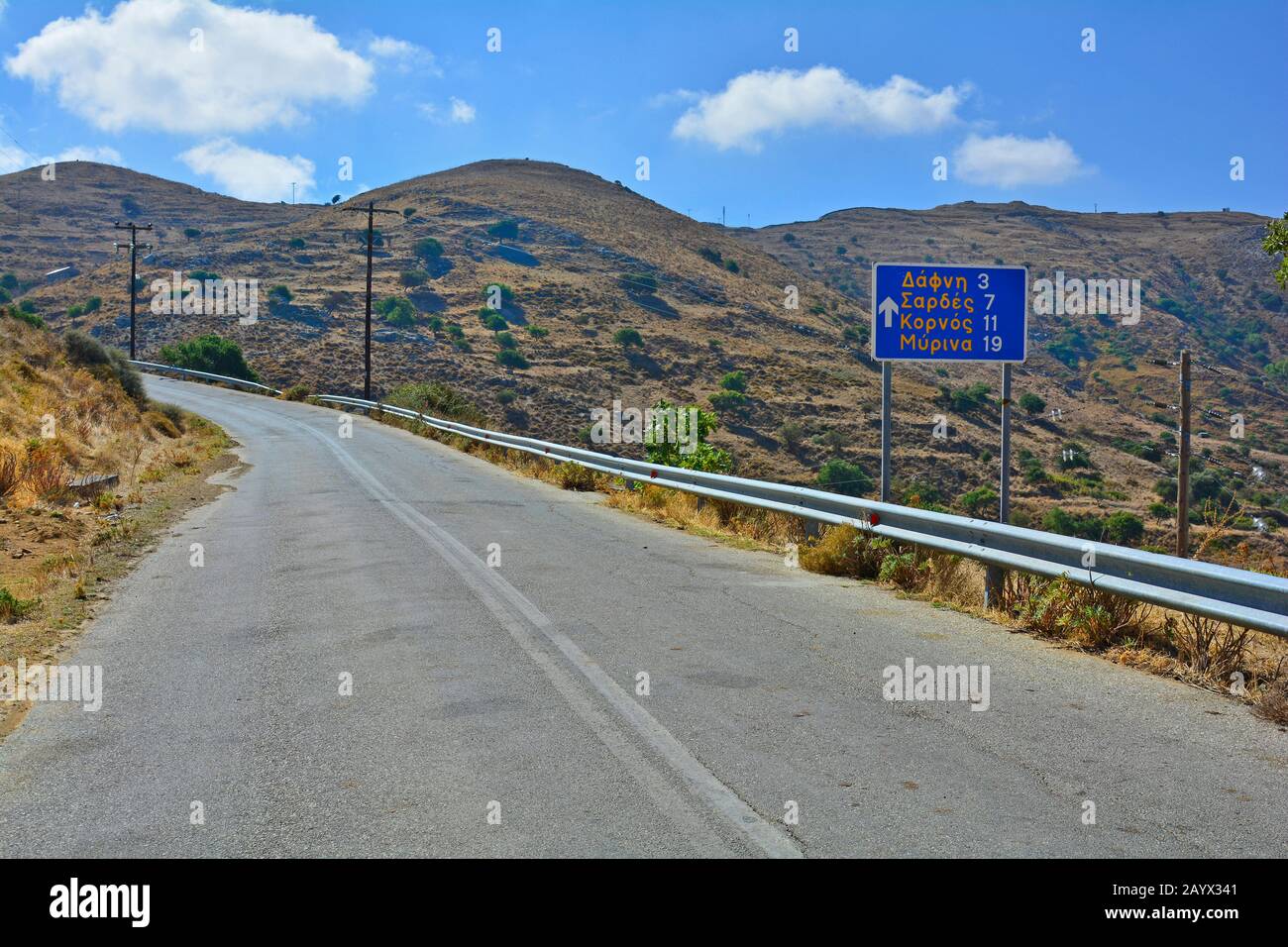 Greece, direction sign in greek characters on mountain road on Lemnos ...