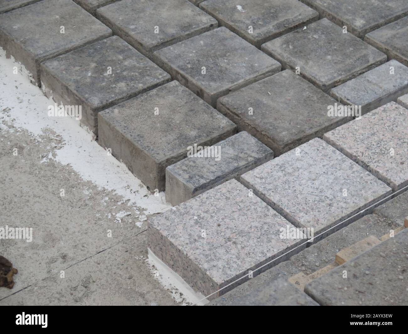 Square paving stones awaiting grouting in village street in Andalusia ...