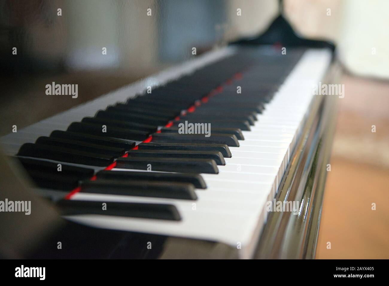 Piano side view with keys lost in the light. Piano keys side view with ...