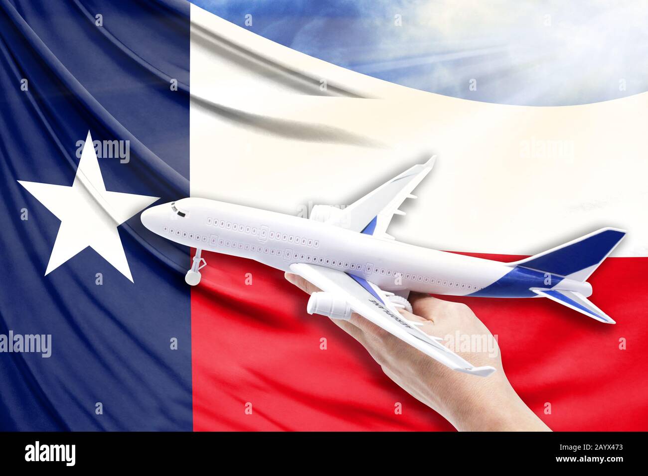 Airplane in hand with national flag State of Texas on a background of ...