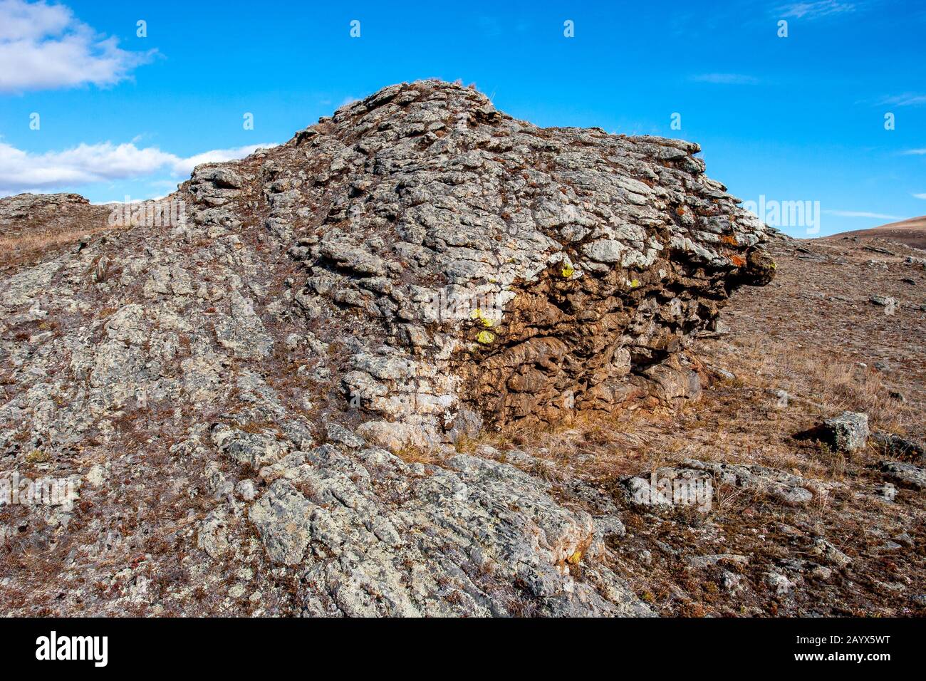 An interesting stone in the steppe with layers with an interesting ...