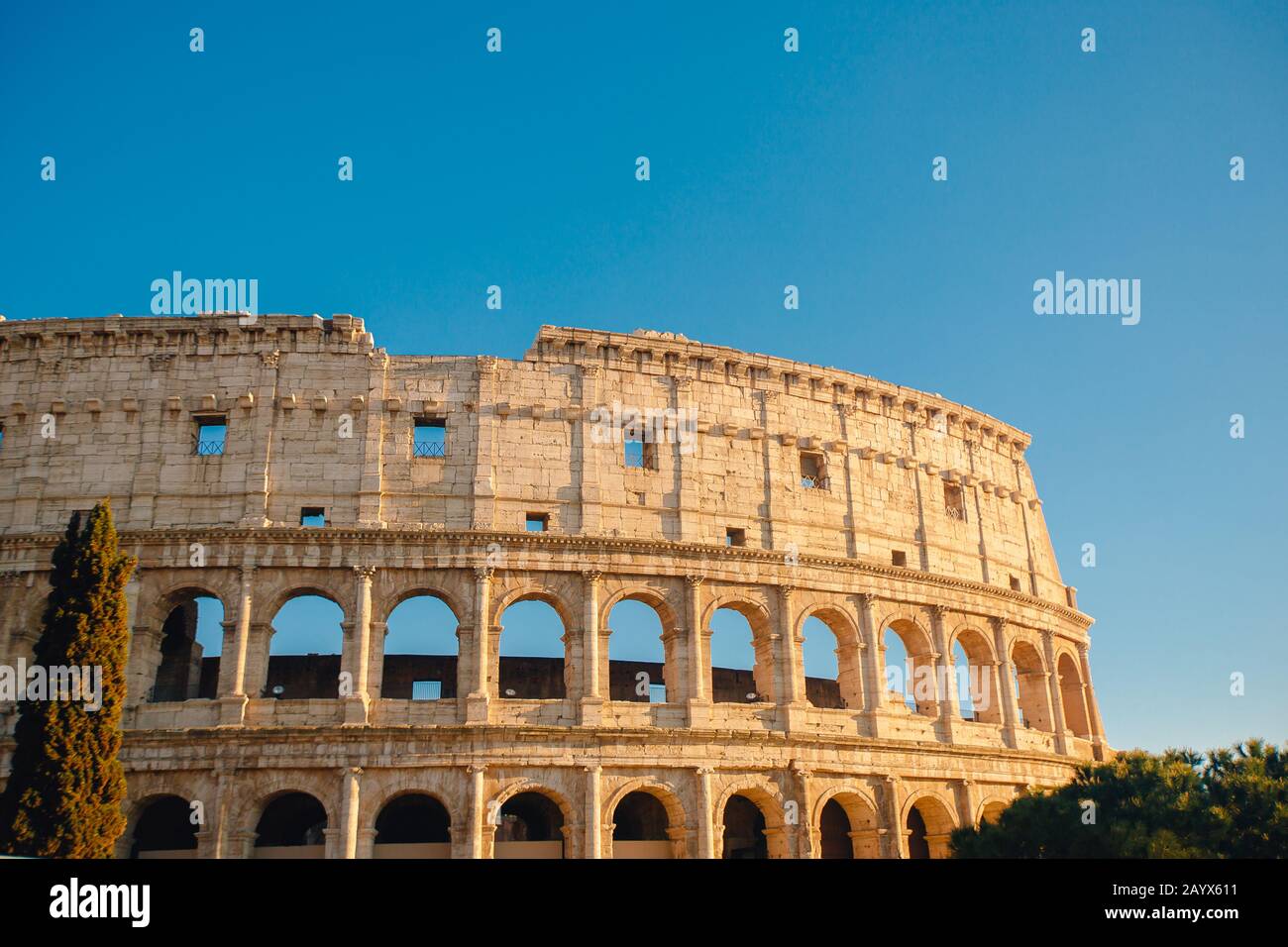 Colosseum or Coliseum ancient ruins background blue sky Rome, Italy ...