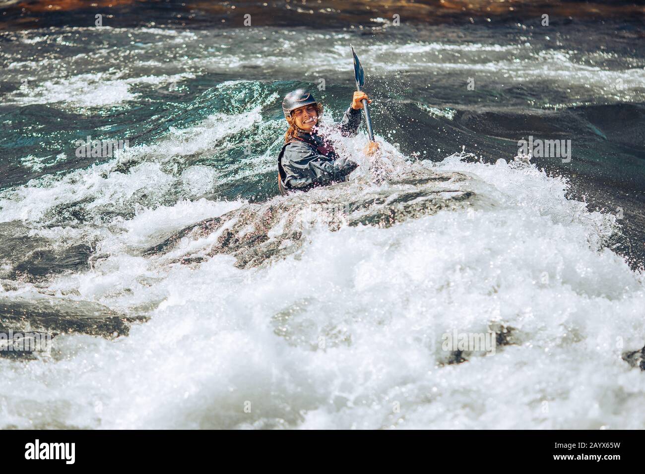 Guy in kayak sails mountain river. Whitewater kayaking, extreme sport ...