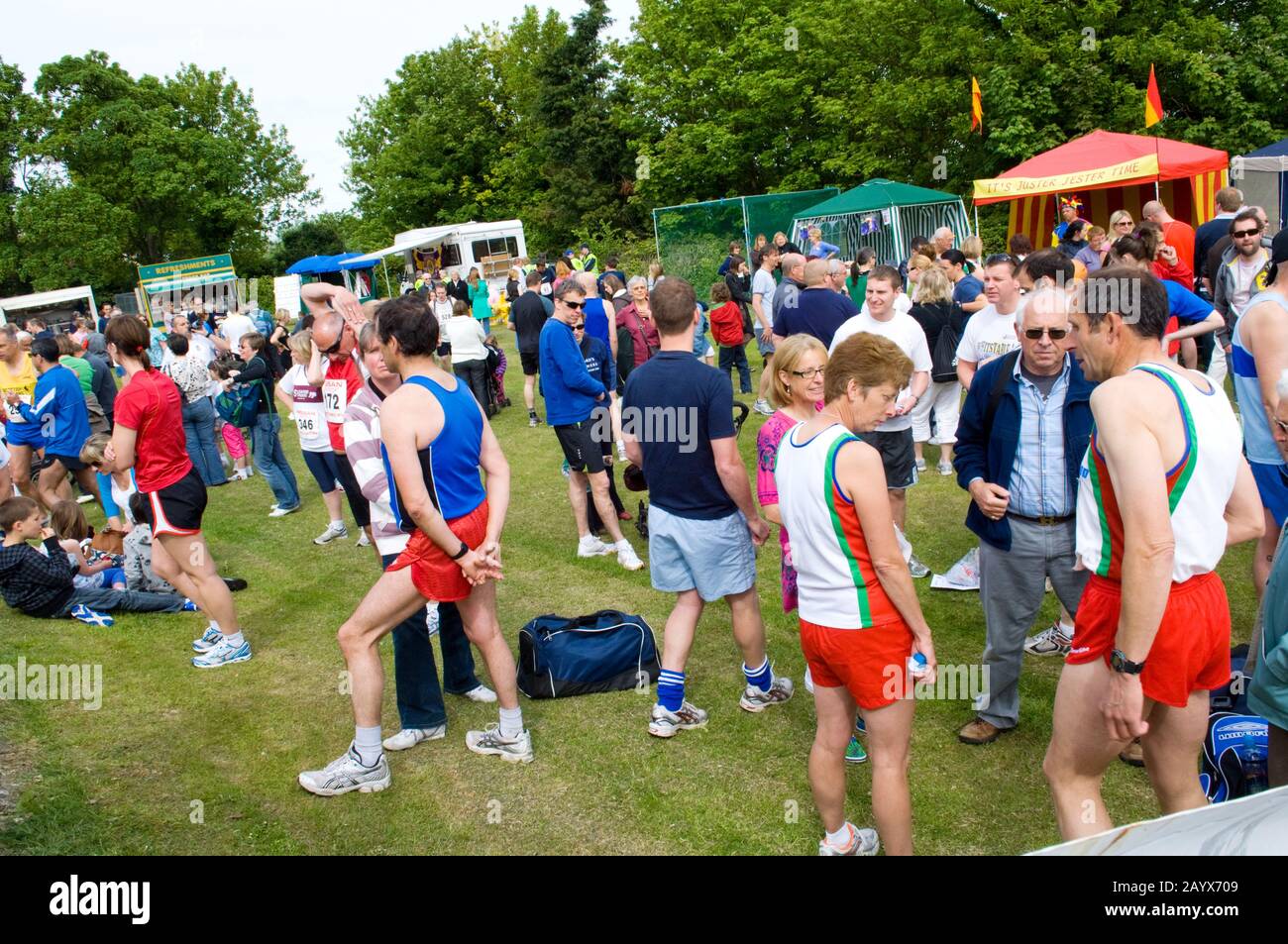 Large crowd of people and some runners waiting for the start of a 10KM ...