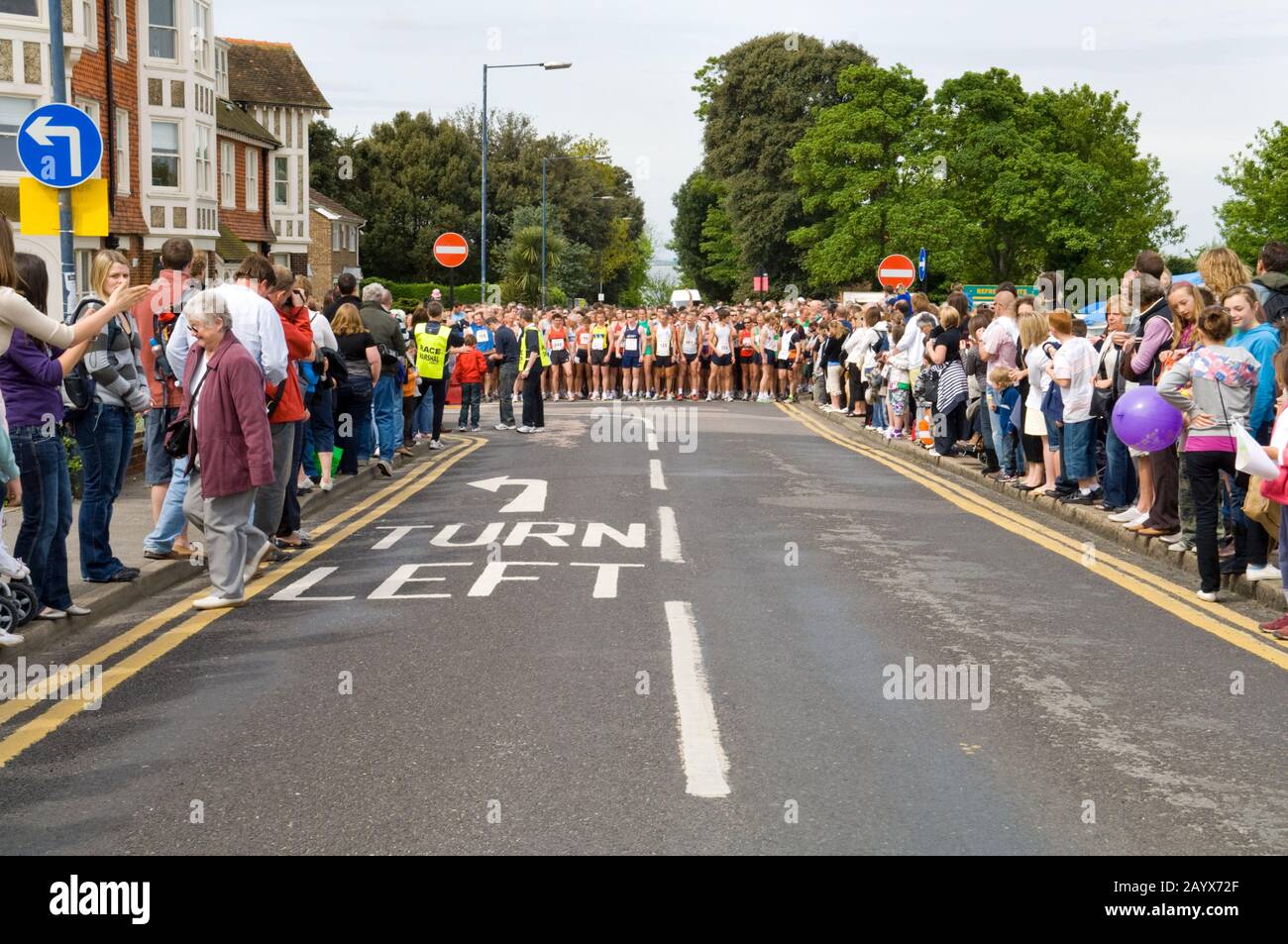 Runners and spectators collecting in the road just seconds prior to the ...