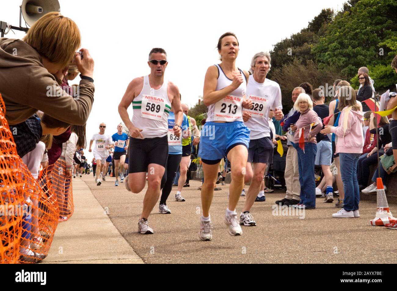 Runners and spectators at a 10KM charity run Stock Photo - Alamy