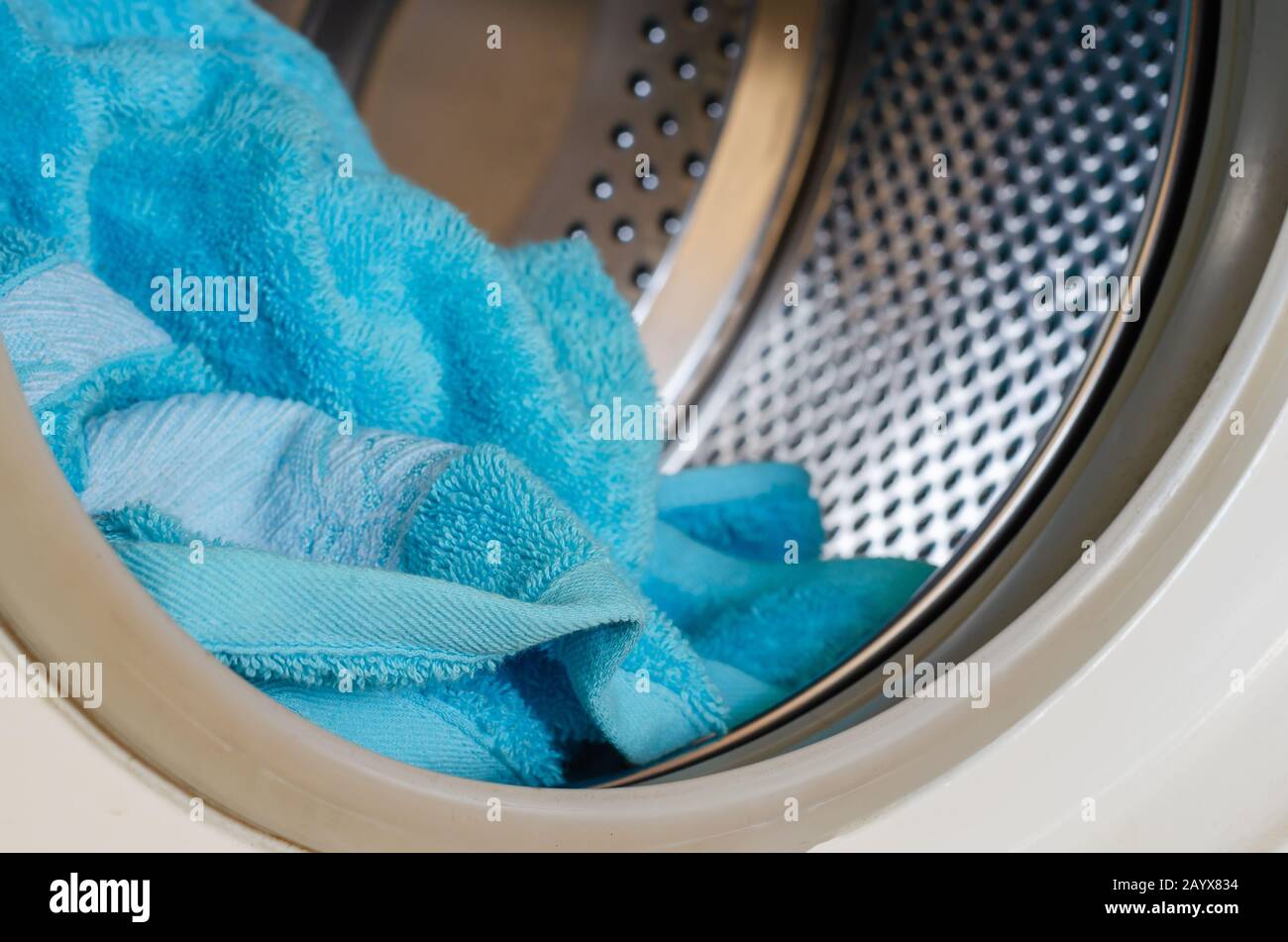 Laundry in a home washing machine. Eye level shooting. Close-up ...