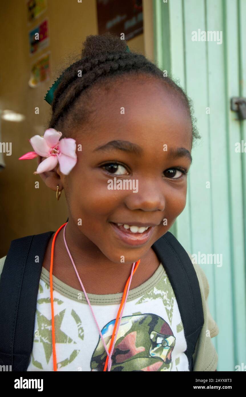 Portrait of a girl with an Oleander flower at her ear in the village of ...