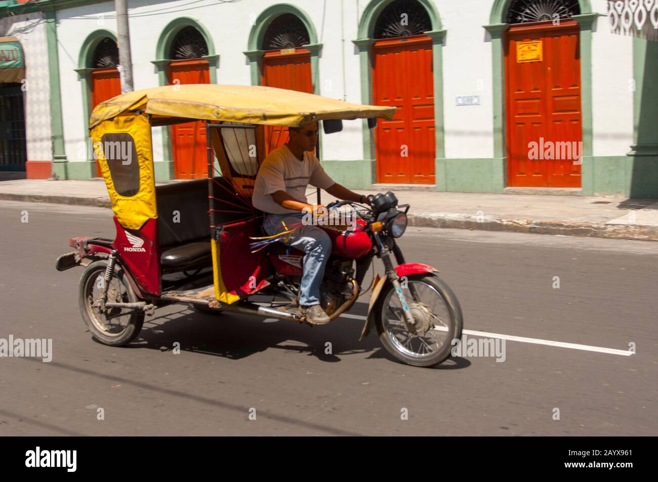 Street scene with a motorcycle taxi in Iquitos, Peru Stock Photo - Alamy