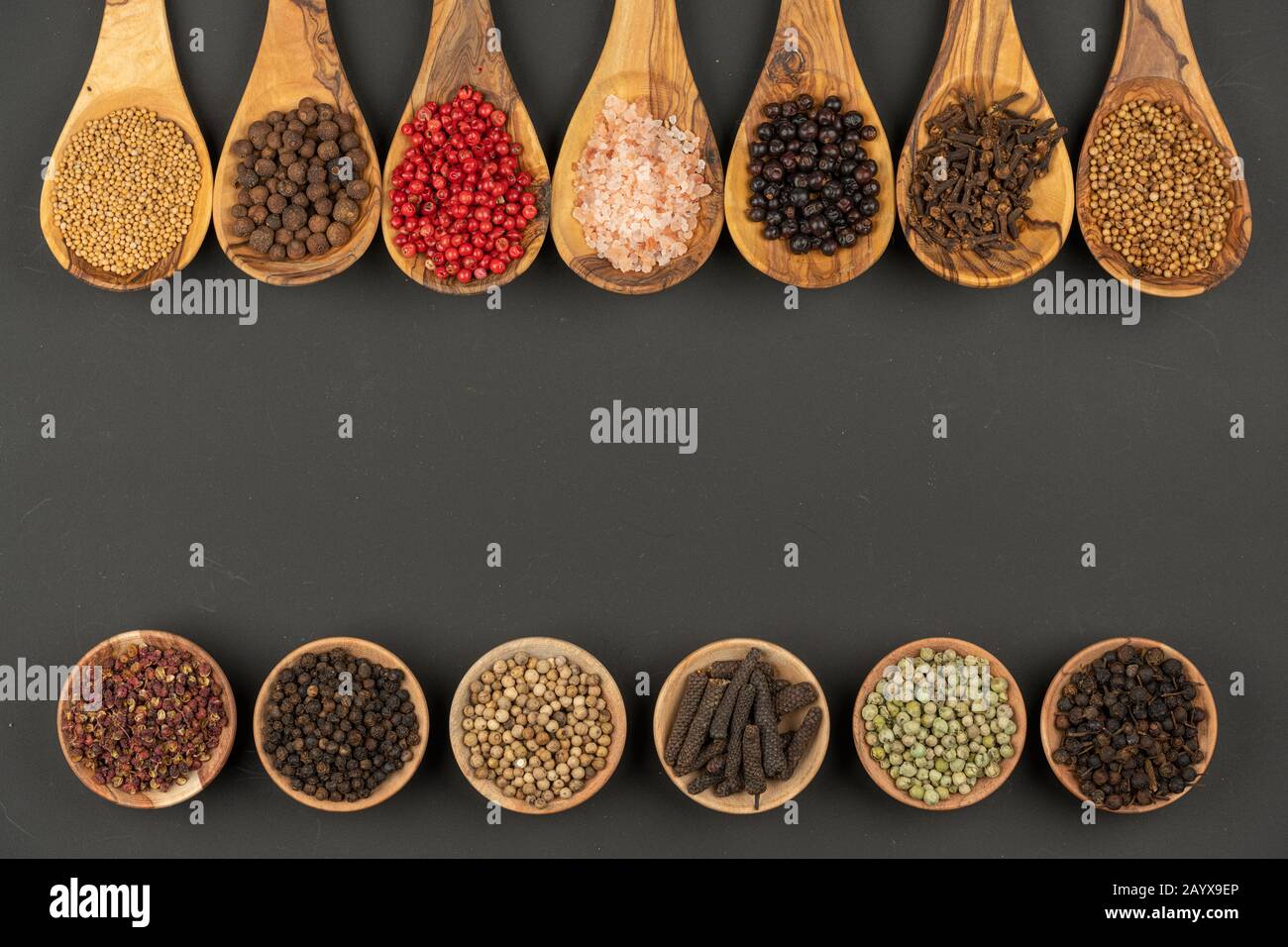 Seven cooking spoons made of olive wood in a row and six small wooden ...