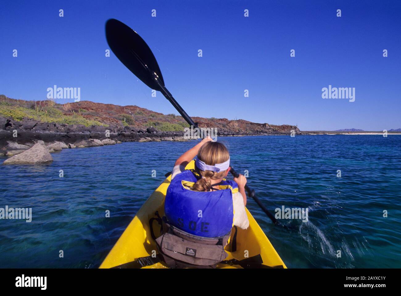 A ten year old girl (Model Release 20020923-7) is kayaking in front of ...