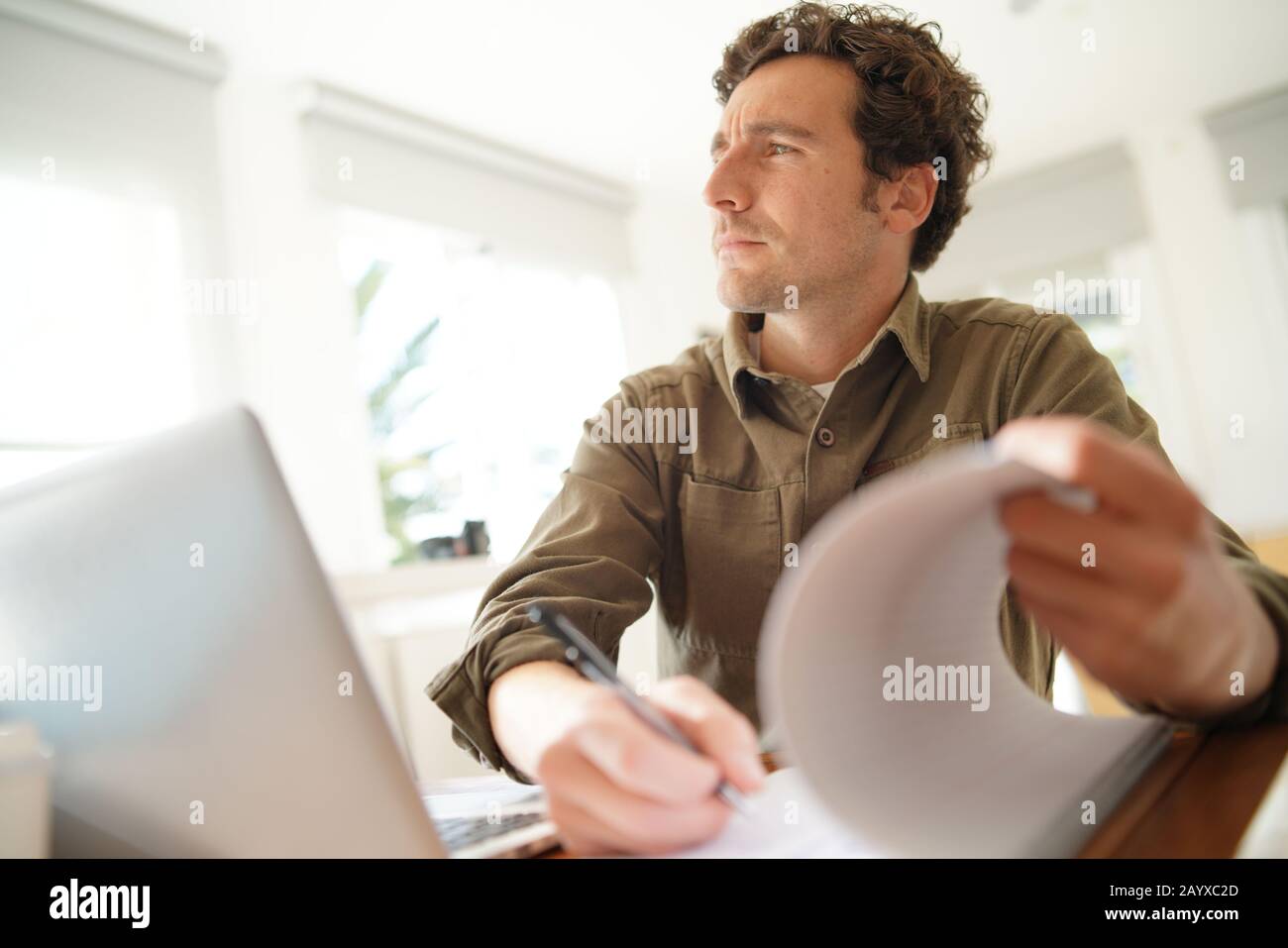 Man using laptop computer in co-working office Stock Photo - Alamy