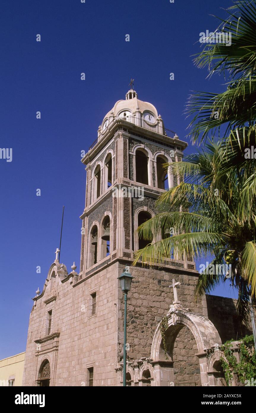 The tower of the Jesuit Mission built in 1697, with palm trees in the ...