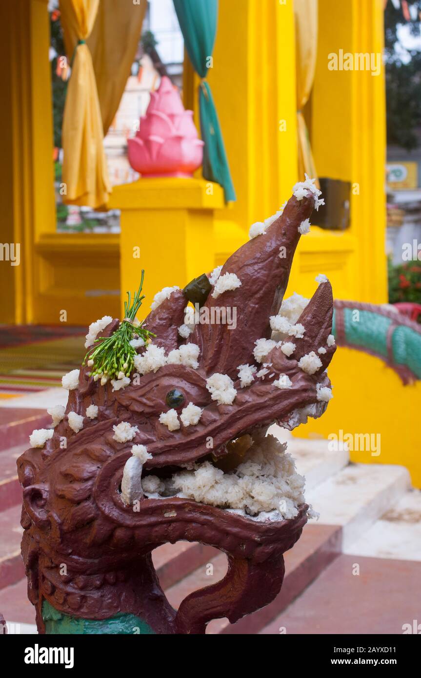 A Naga with rice offerings at a temple in Vientiane, the capital and ...