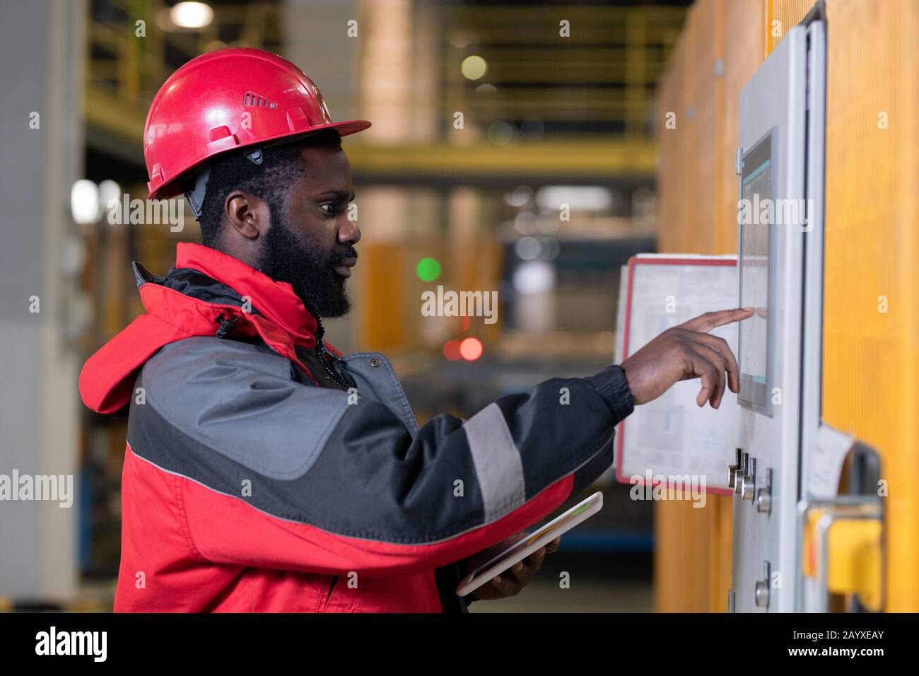 Horizontal medium side view portrait of professional Black male factory ...