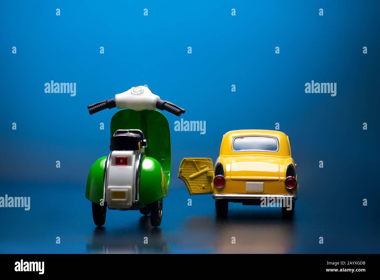 Yellow car and a motorcycle behind it. Yellow car opens the door and it ...