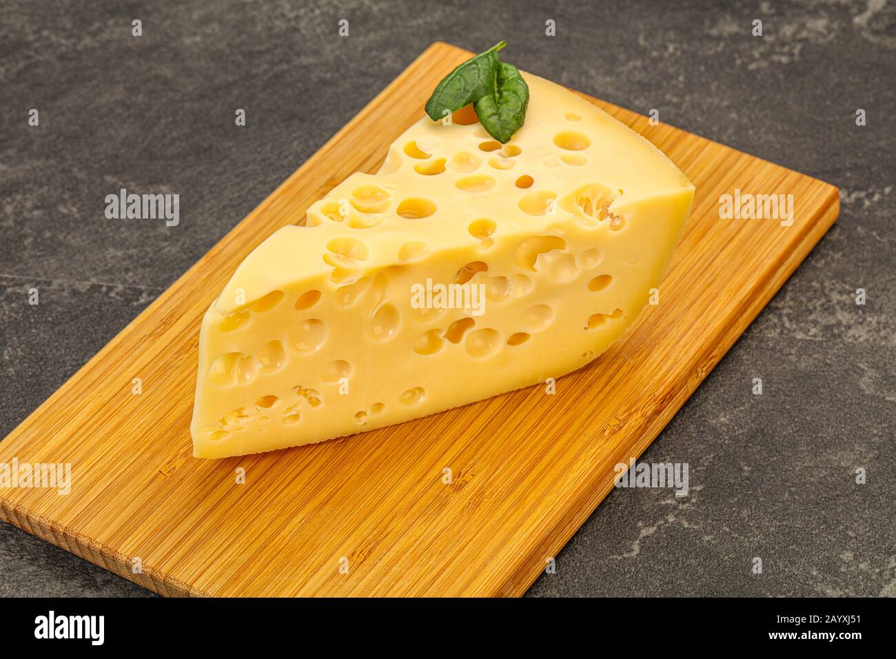 Maasdam cheese - dairy yellow triangle with holes Stock Photo - Alamy