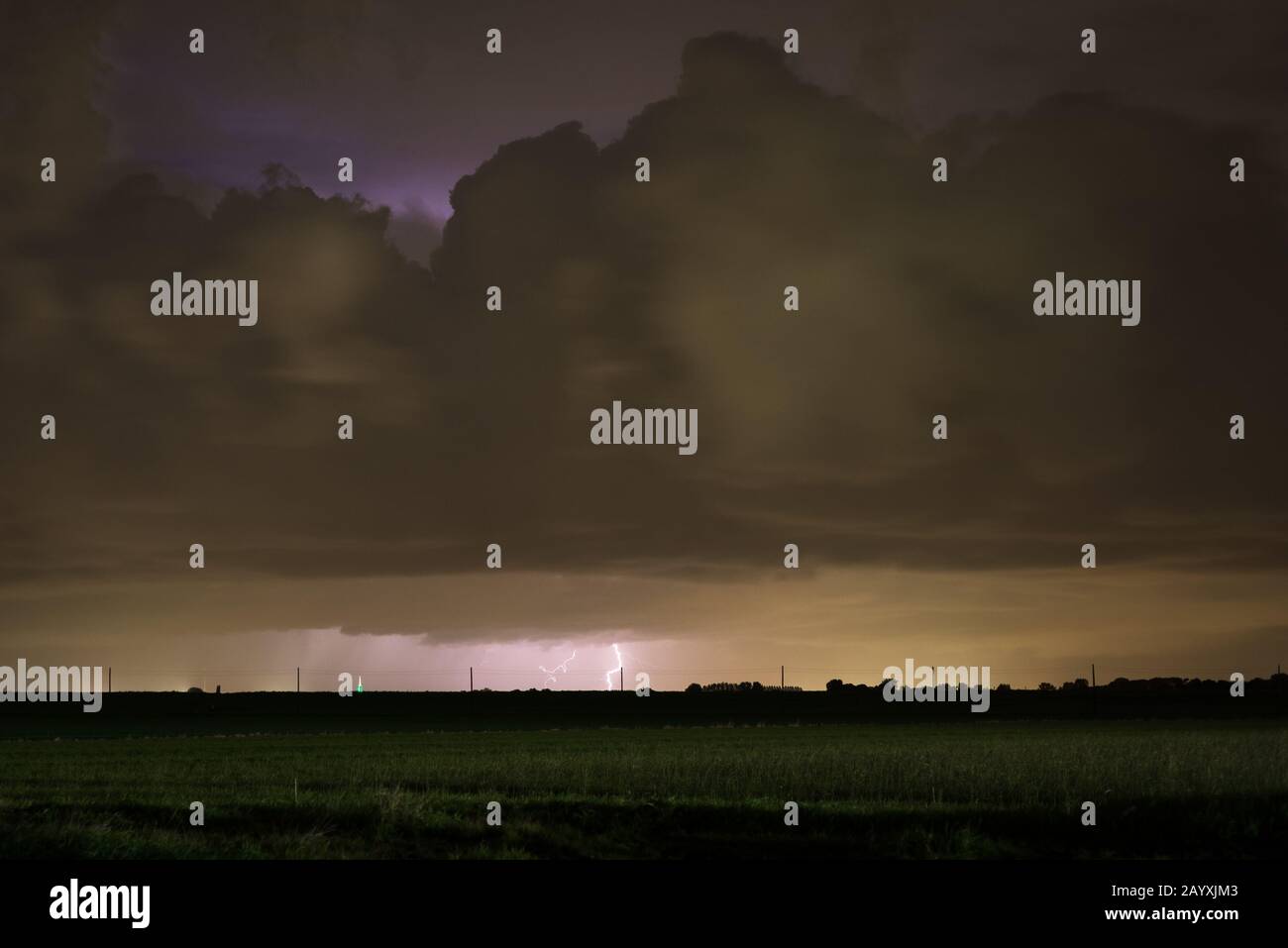 Lightning striking down from a distant thunderstorm Stock Photo - Alamy