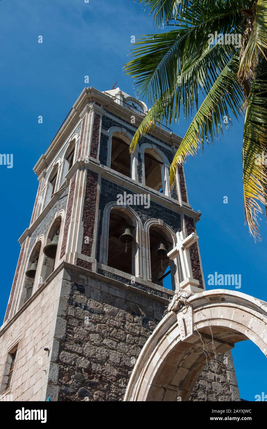 The tower of the Jesuit Mission built in 1697, with palm trees in the ...