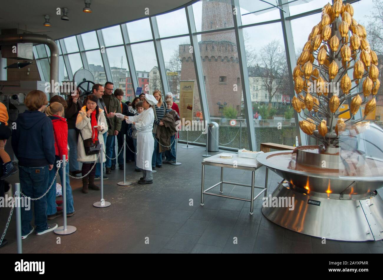 Woman passing out chocolate samples from the chocolate fountain to ...