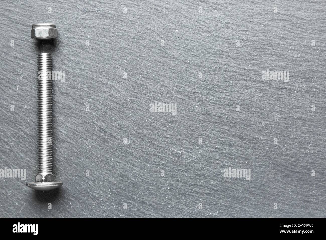 Stainless steel screws on a black texture background Stock Photo - Alamy