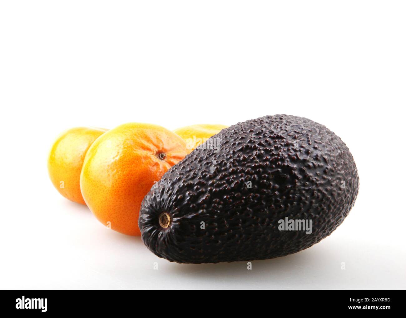 Avocado And Mandarin Orange Against White Background Stock Photo - Alamy