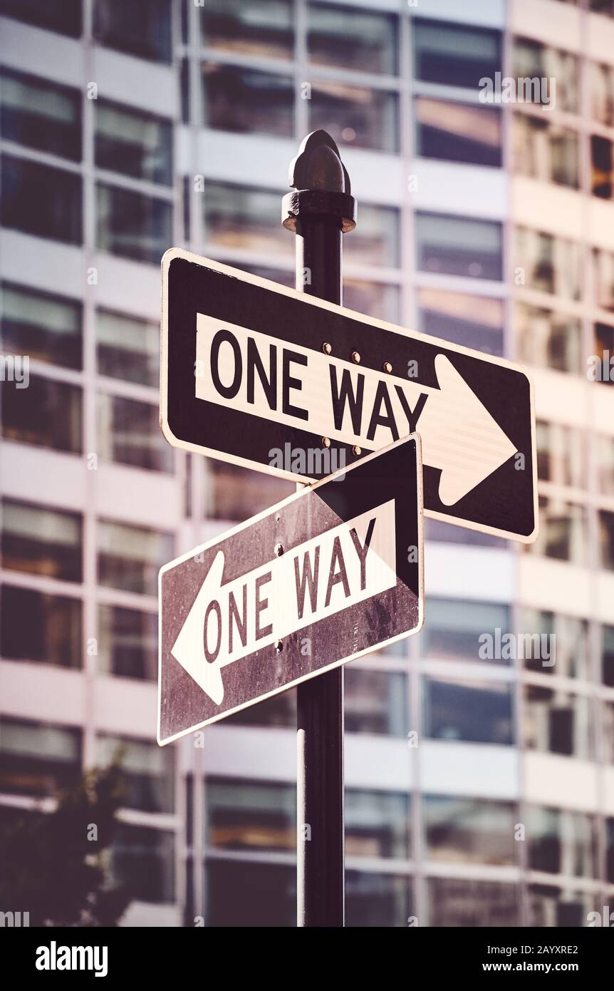 Retro toned picture of one way street signs in New York City, selective ...