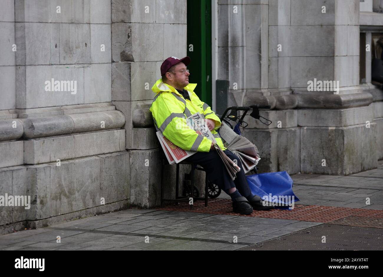Traditional newspaper crier outside the Post Office on Oliver Plunkett ...