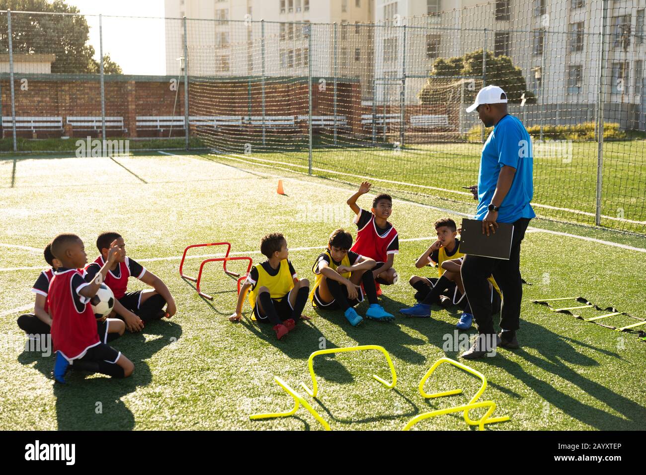 Soccer players listening to their coach Stock Photo - Alamy
