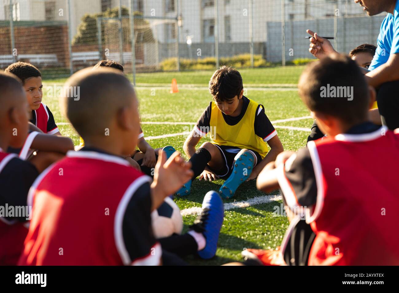 Soccer players listening to their coach Stock Photo - Alamy