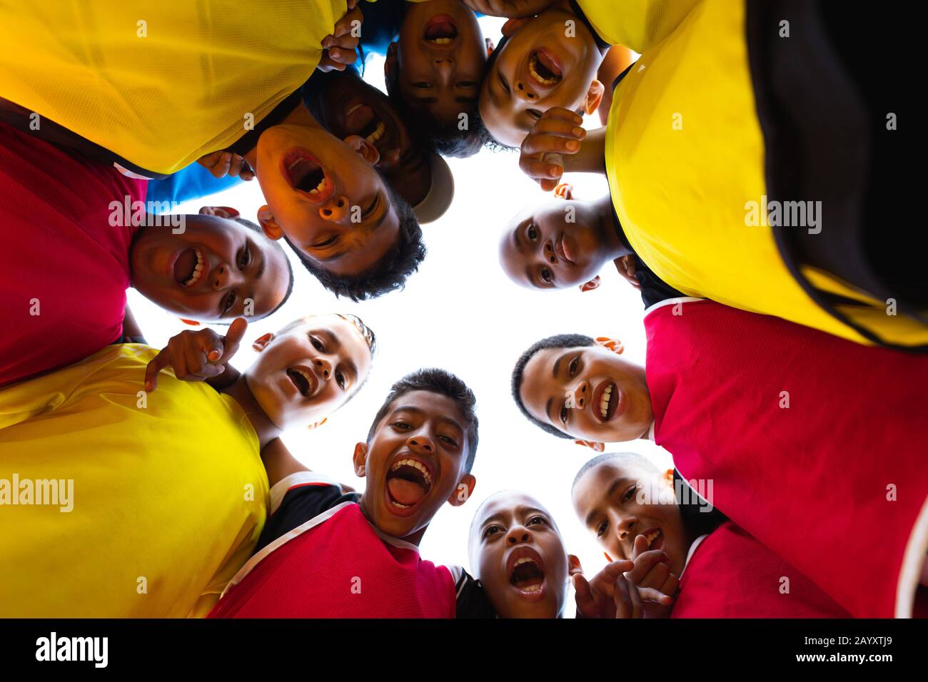 Low angle view of soccer team in circle Stock Photo - Alamy