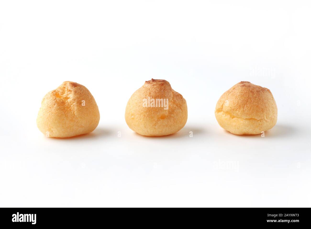 cream puffs aligned closeup isolated on white background Stock Photo ...