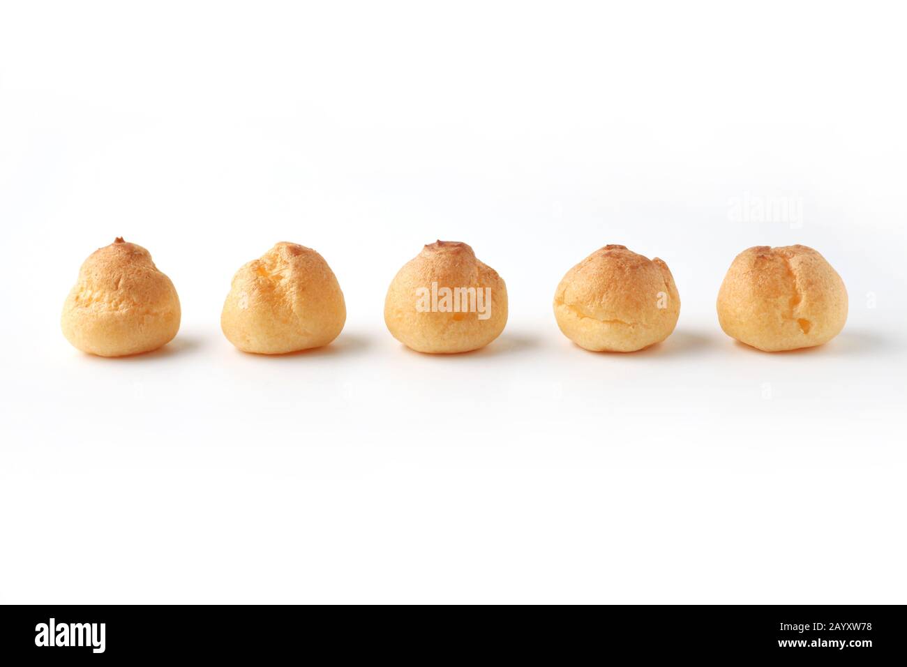 cream puffs aligned closeup isolated on white background Stock Photo ...