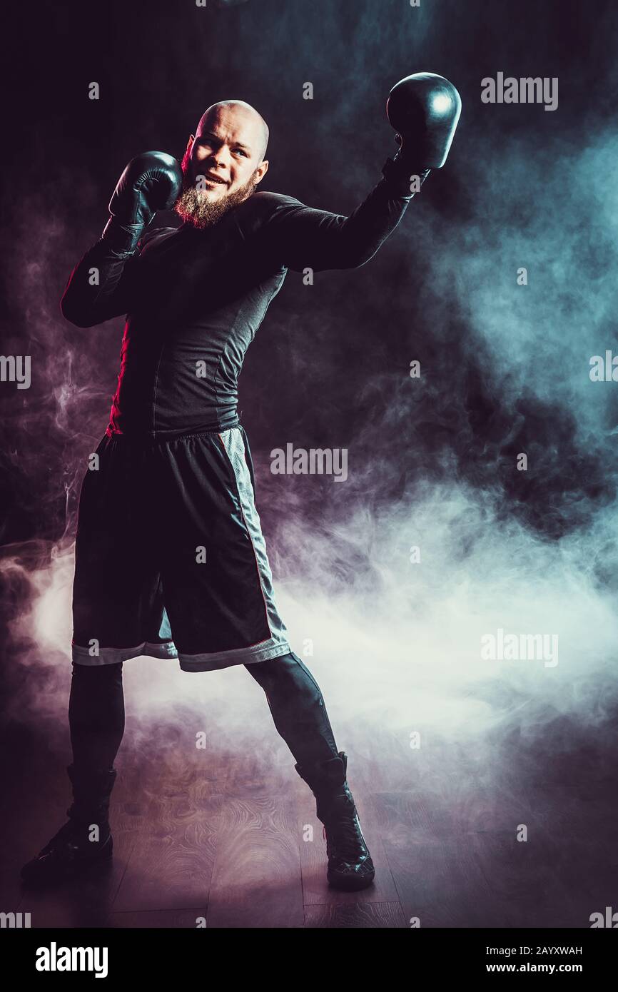 Sportsman boxer fighting on black background with smoke. Boxing sport ...
