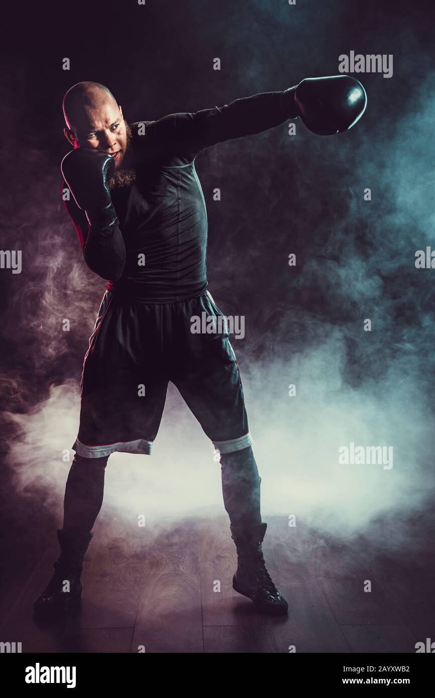 Sportsman boxer fighting on black background with smoke. Boxing sport ...