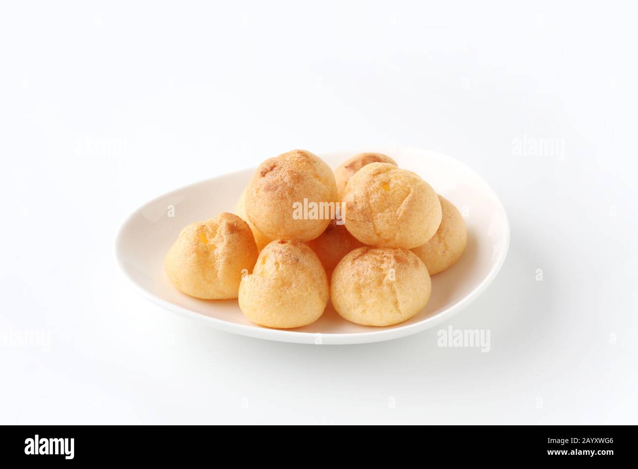 cream puffs on plate closeup isolated on white background Stock Photo ...