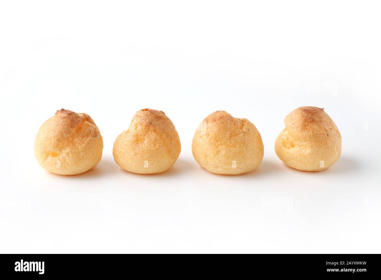 cream puffs aligned closeup isolated on white background Stock Photo ...