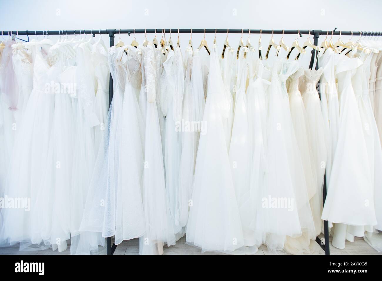 Horizontal no people shot of beautiful wedding dresses on clothes rails ...