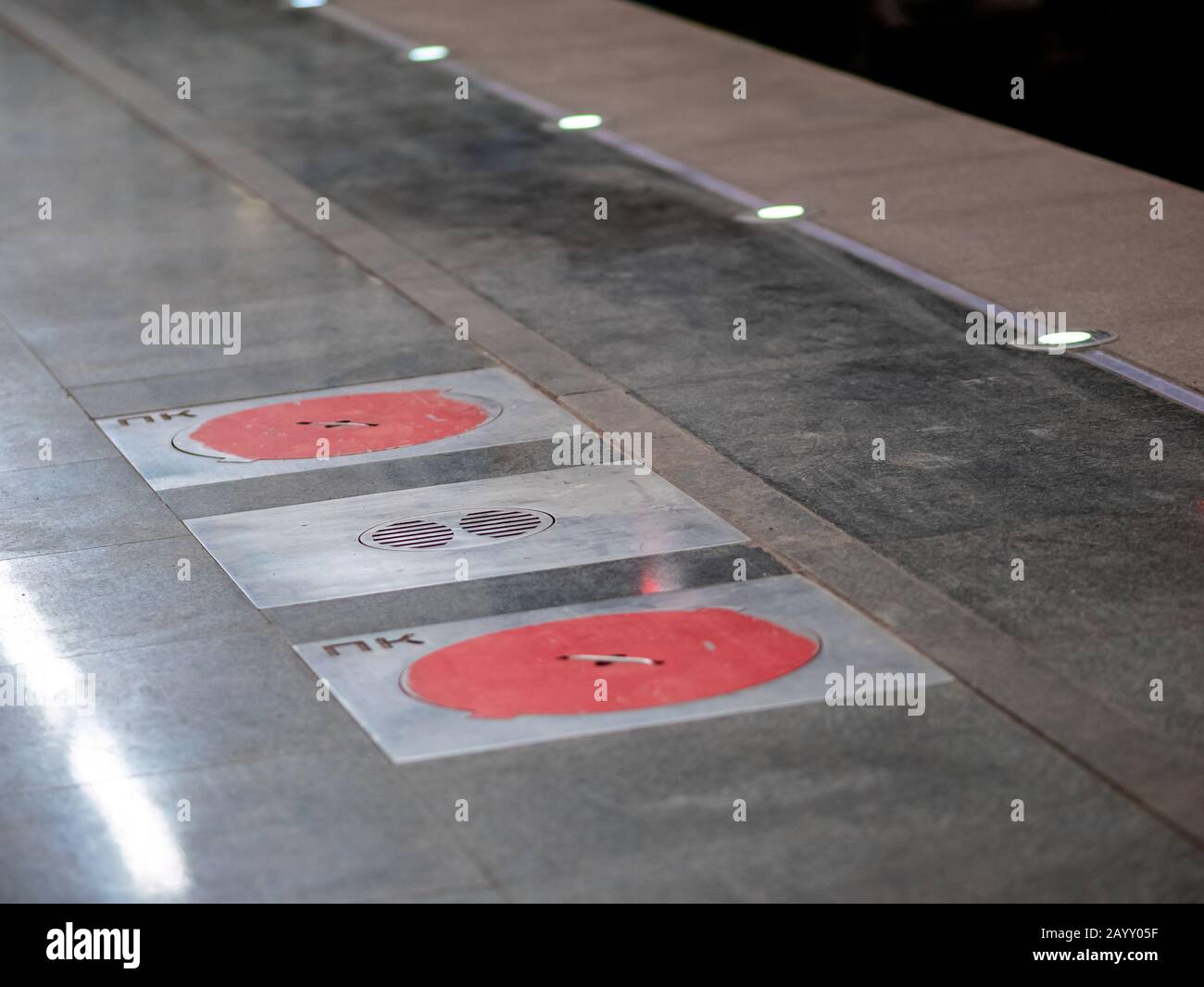 Fire hatches at the Moscow metro station. Red covers on the floor of ...