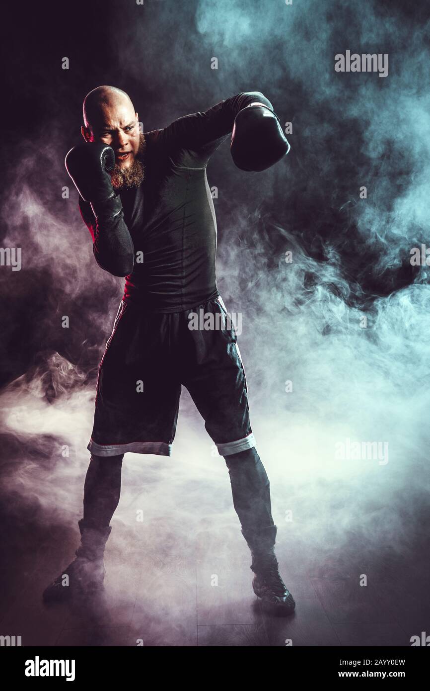 Sportsman boxer fighting on black background with smoke. Boxing sport ...