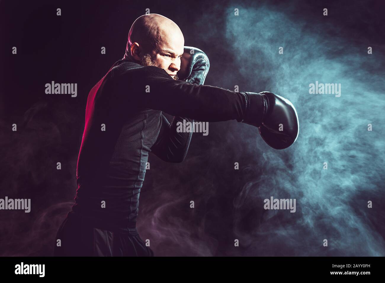 Sportsman boxer fighting on black background with smoke. Boxing sport ...