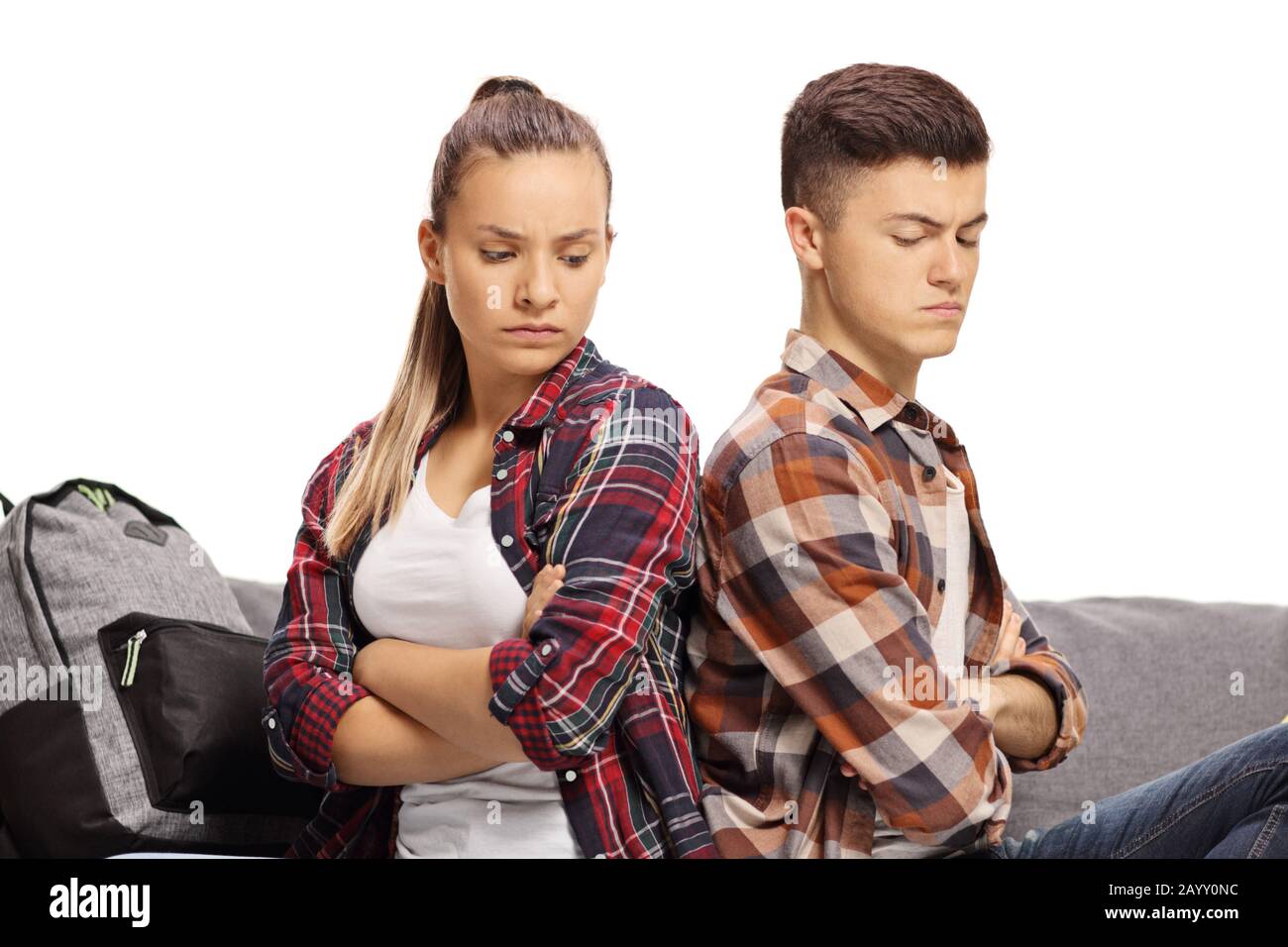 Young boy and girl sitting angry with each other isolated on white ...