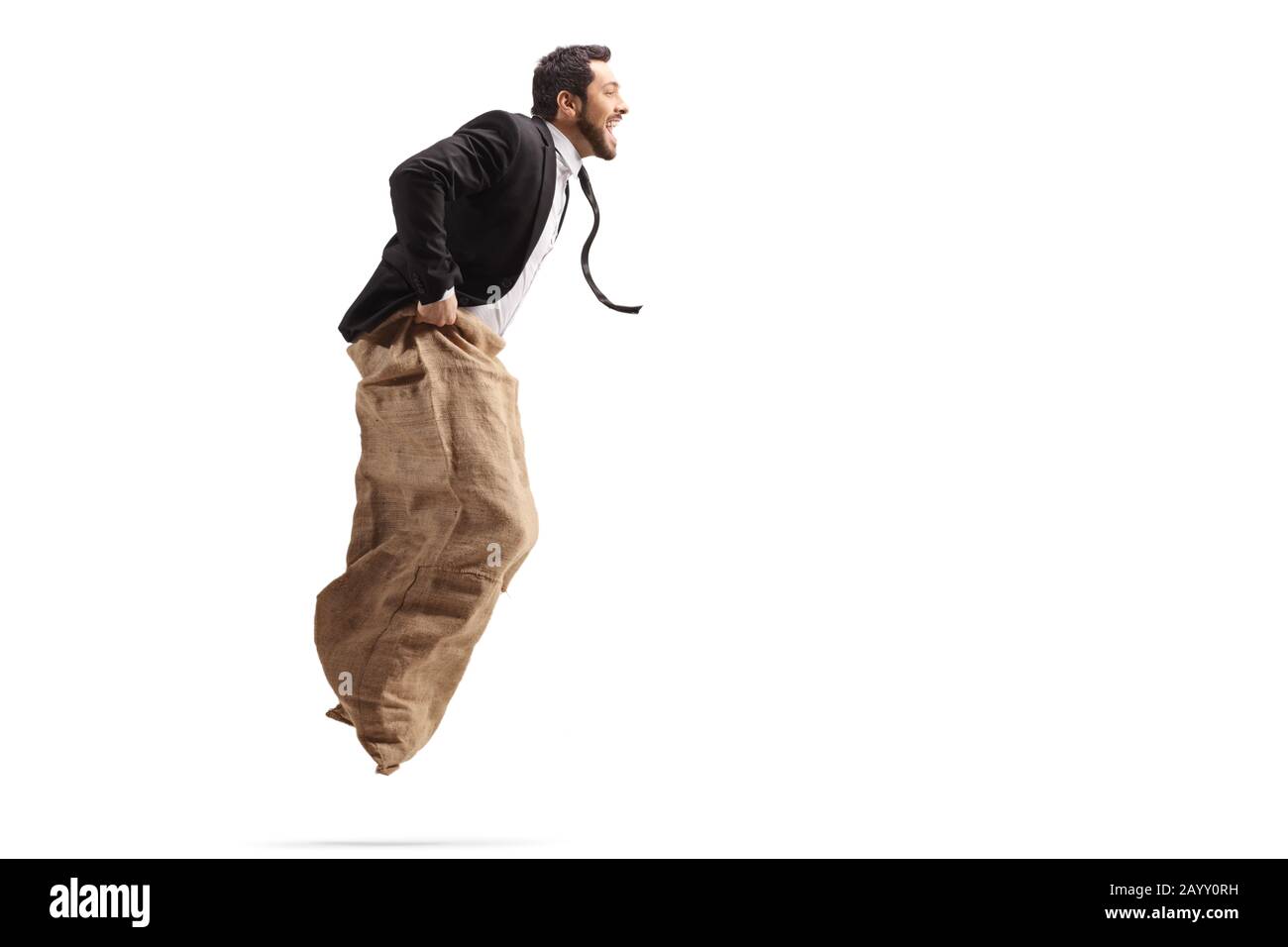 Man in a suit playing a game with jumping in a sack isolated on white ...