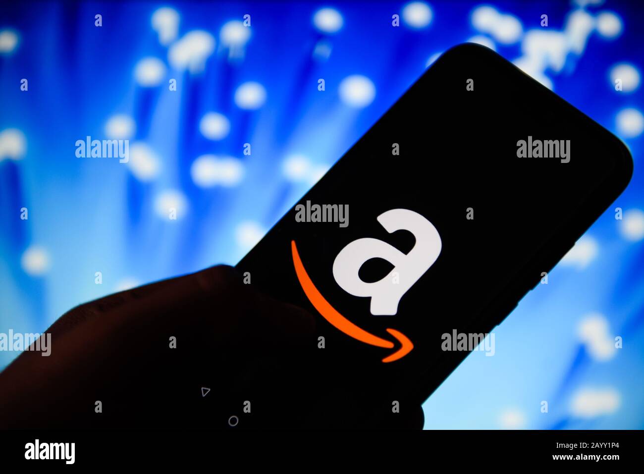 In this photo illustration an Amazon logo seen displayed on a ...