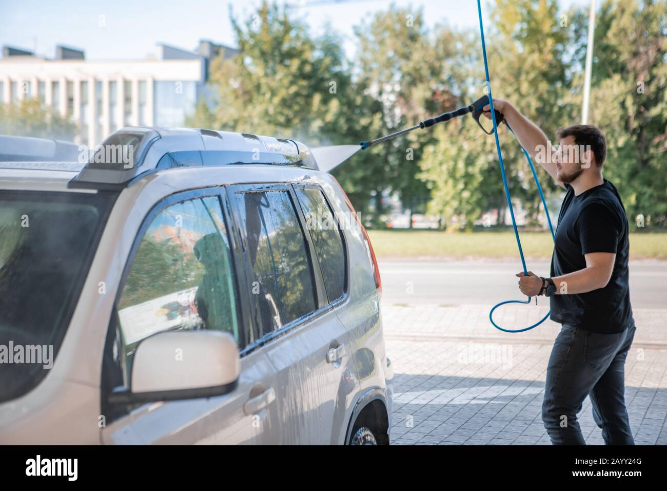 strong man washing car at self carwash outdoors Stock Photo - Alamy