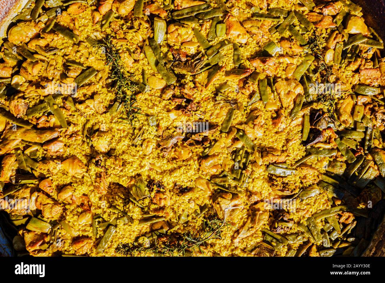Yellow rice with meat and vegetables, Valencian paella, typical dish of ...