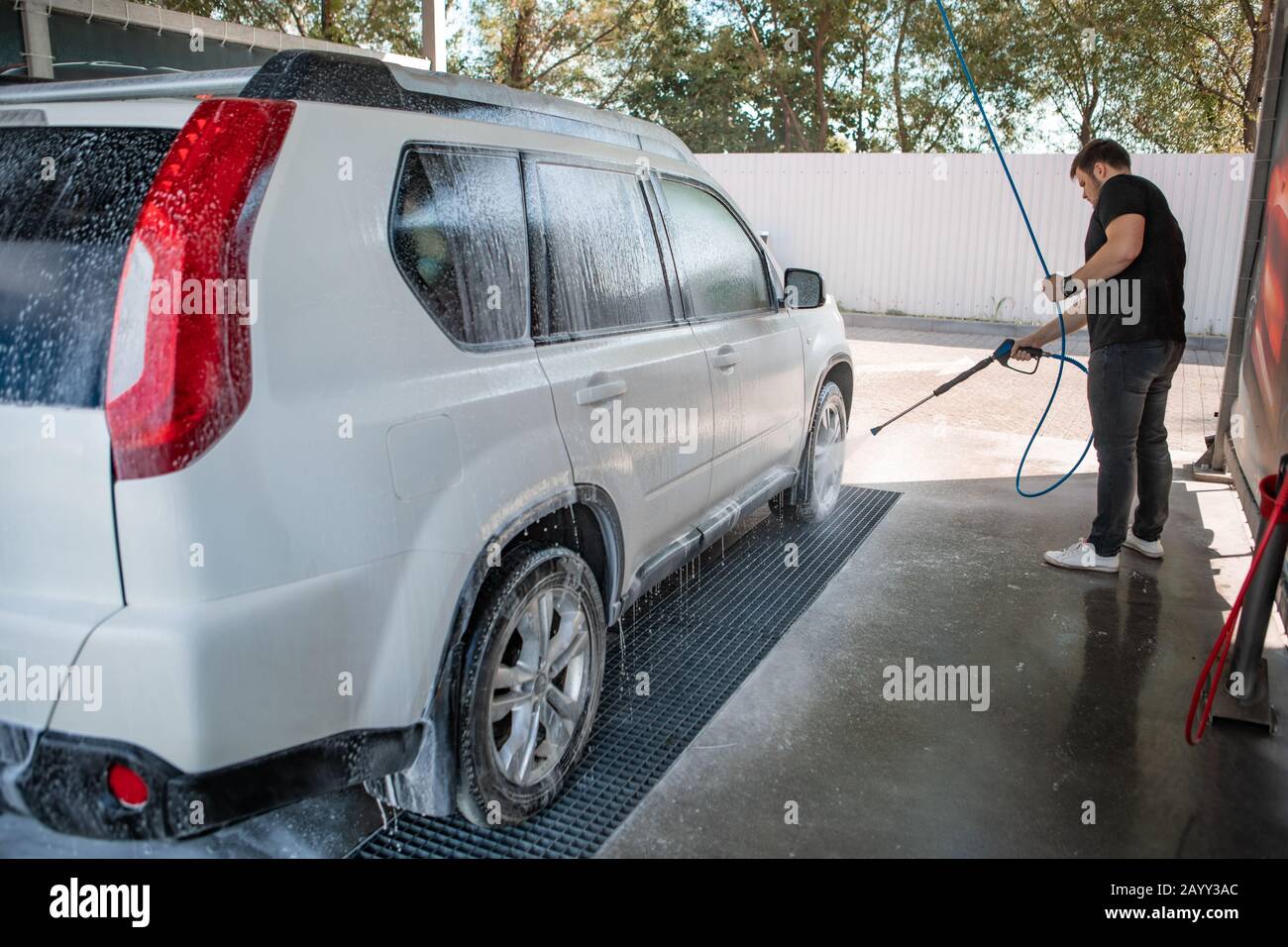 strong man washing car at self carwash outdoors Stock Photo - Alamy