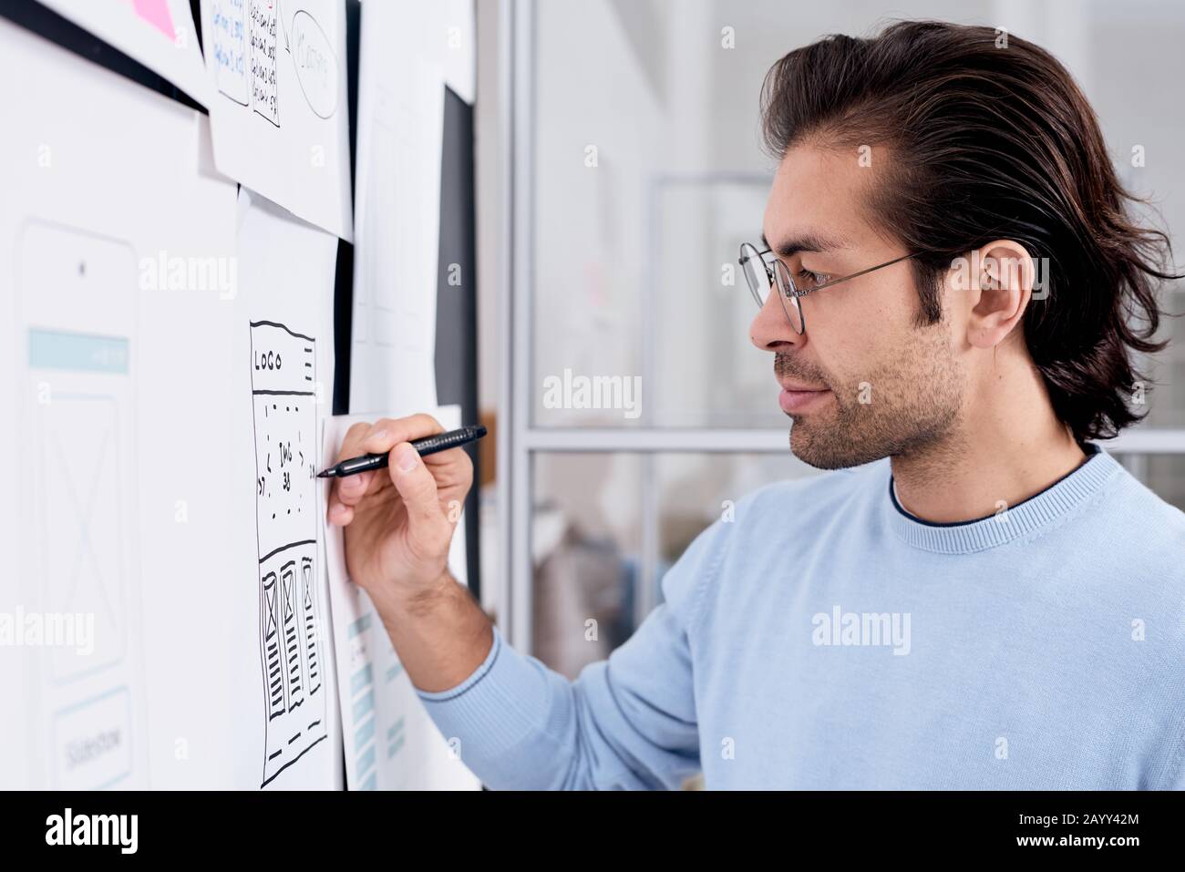 Horizontal side view chest up portrait of young male application ...