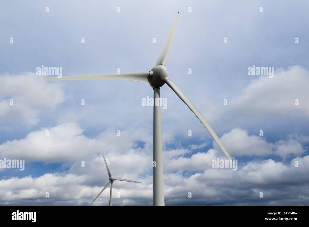 two wind wheels in front a cloudscape Stock Photo - Alamy