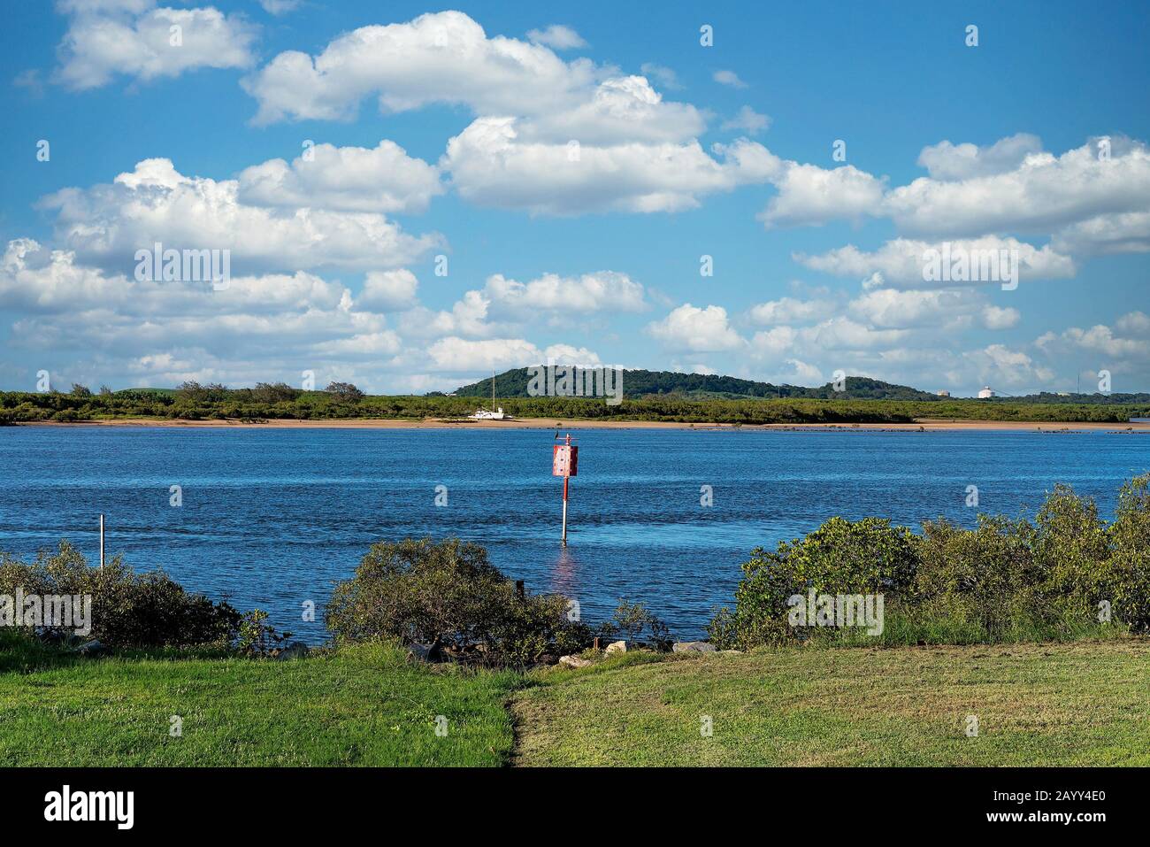 Signage indicating the channel of a river with a stranded boat in the ...